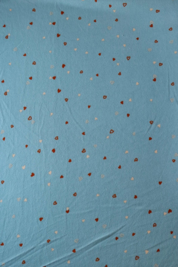 Tossed Hearts on Chambray Brushed Sweater Knit | Surge Fabric Shop